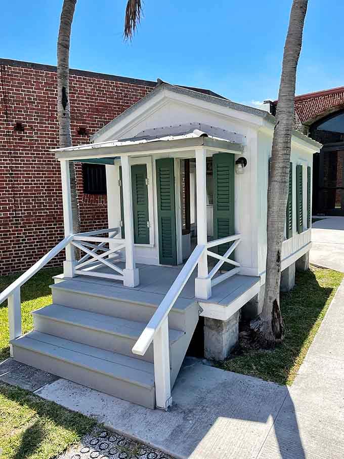 The charming Conch house replica showcases traditional Key West architecture, offering a stark contrast to the fort's imposing military construction nearby.