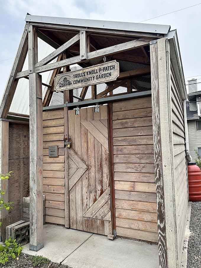 The community garden near the troll shows how art and nature coexist in this quirky neighborhood paradise.