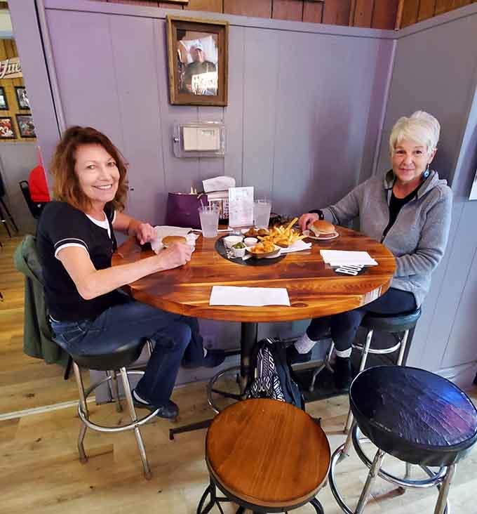 Happy diners at their table prove that good food brings people together, no matter where you're from or why.