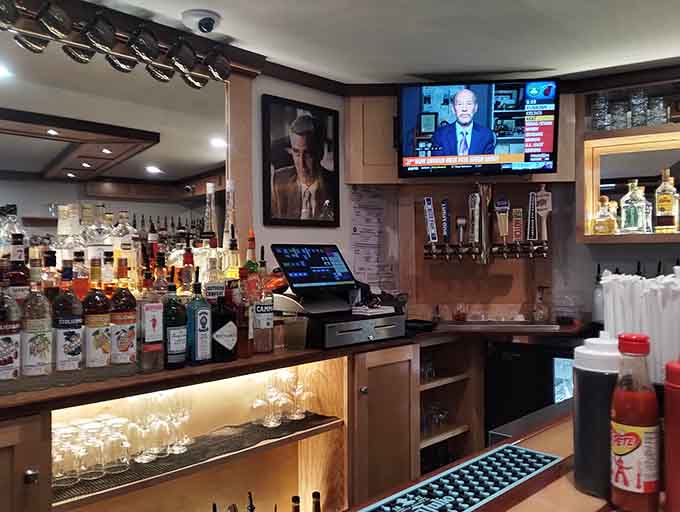 The bar at George's where drinks flow and conversations happen&mdash;a proper neighborhood gathering spot with character and cold beer.