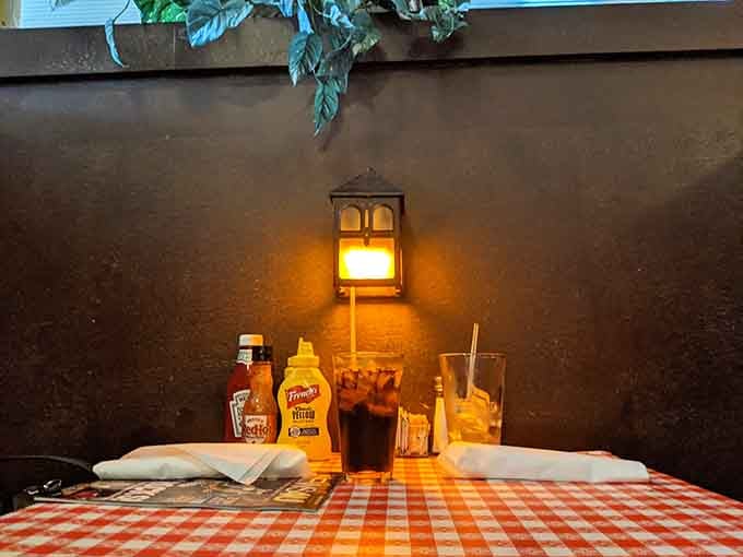 Classic condiments on checkered tablecloths set the stage for a meal that's refreshingly unpretentious and genuinely satisfying.