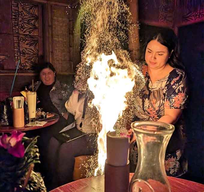 Watching the bartenders work is half the fun, as they craft elaborate drinks with theatrical flair.