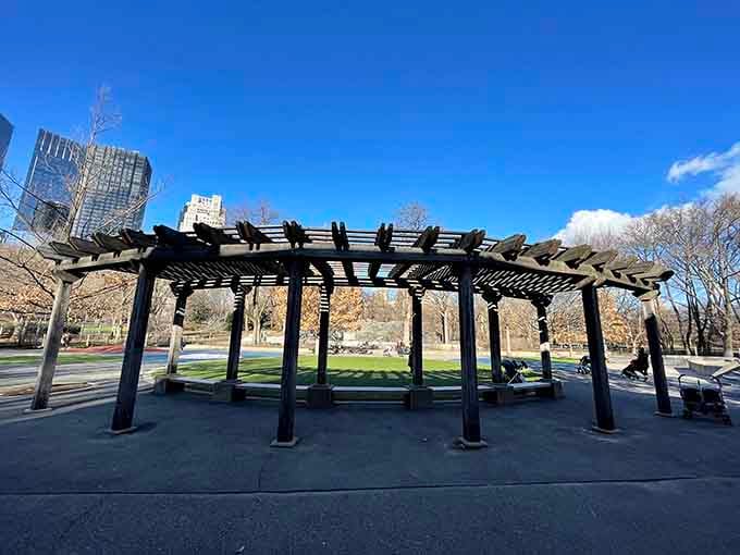 This wooden pergola structure provides welcome shade for parents who've been sitting in the sun watching kids play endlessly.
