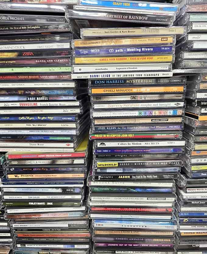 CD towers representing the awkward middle child between vinyl and streaming, when we thought digital meant owning physical discs.