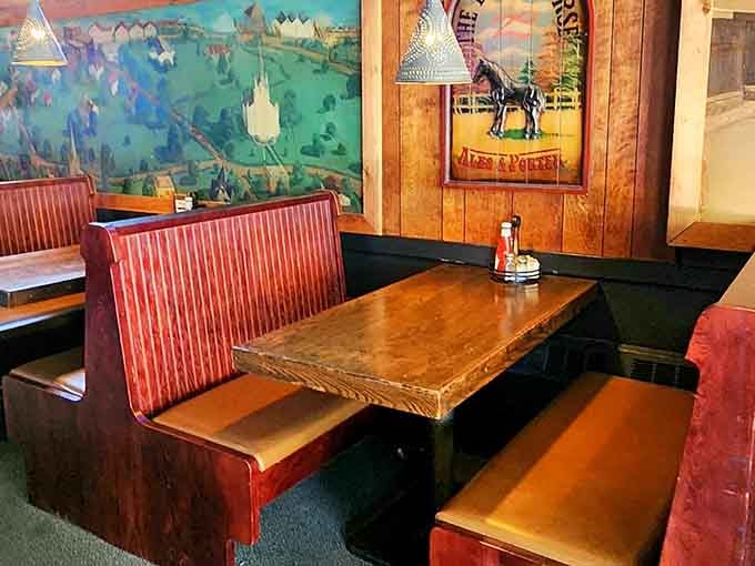 Colorful murals on the walls add unexpected whimsy to the wood-paneled interior, creating visual interest throughout.