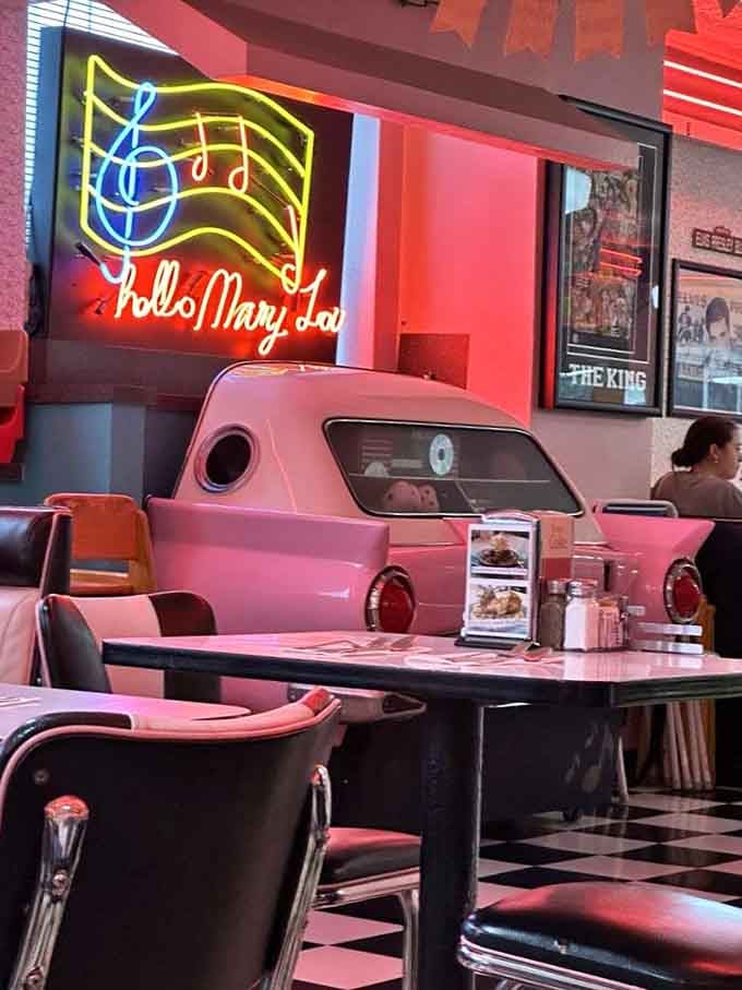 That "Hello Mary Lou" neon sign and vintage car booth create the perfect backdrop for pretending you've just stepped out of American Graffiti.