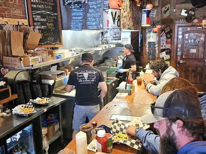 Behind the bar, the kitchen crew works their magic while surrounded by decades of collected treasures.