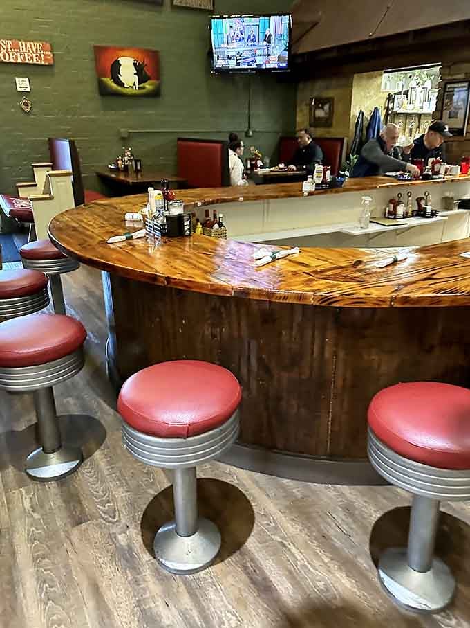 Retro counter seating with red vinyl stools brings back the golden age of American diners with style.