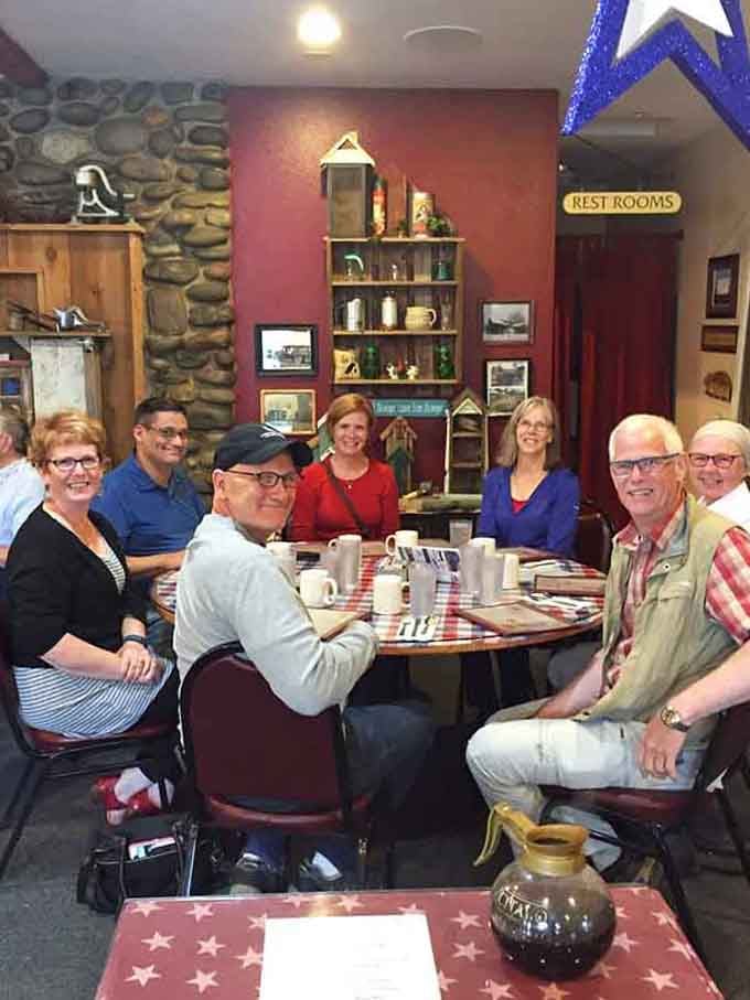 Tables full of happy diners sharing coffee and conversation, exactly what restaurants were meant to be before everyone started scrolling.
