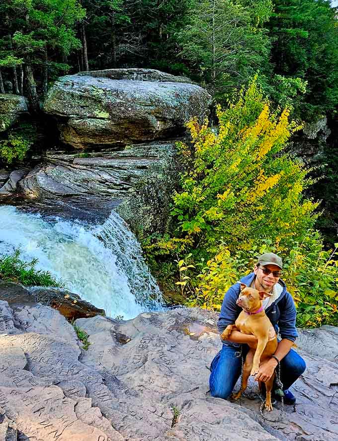 The trail winds through dense forest where even four-legged hikers can appreciate the mountain scenery together.