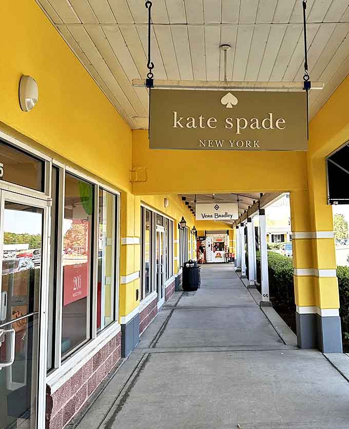 Kate Spade's elegant sign hangs like a beacon of sophisticated style. The covered walkway ensures your new designer finds won't get dampened by anything but your enthusiasm.