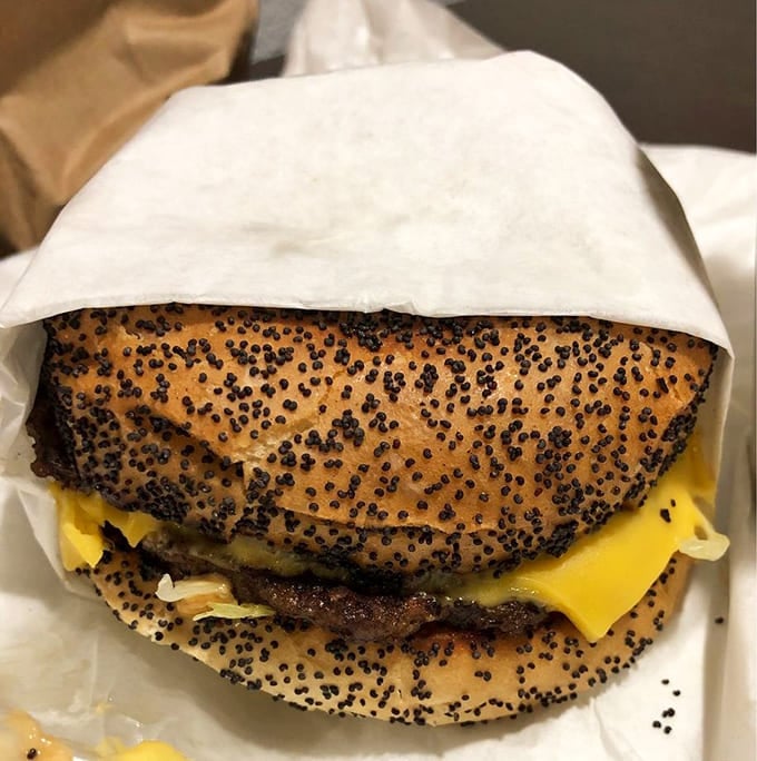 A cheeseburger wrapped in paper, ready to deliver the kind of satisfaction that fancy restaurants can only dream about.