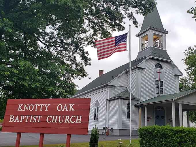 Knotty Oak Baptist Church stands as a testament to New England's religious heritage, its white steeple pointing skyward like a celestial signpost.