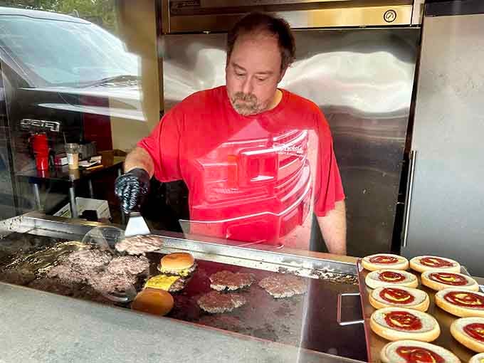 Behind every great burger stand is someone working that griddle like a maestro conducting a delicious symphony of sizzle.
