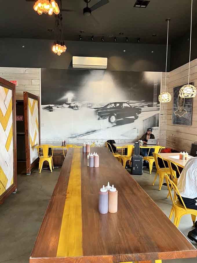 Long communal tables and that striking black-and-white mural create a space where strangers become friends over fantastic food.