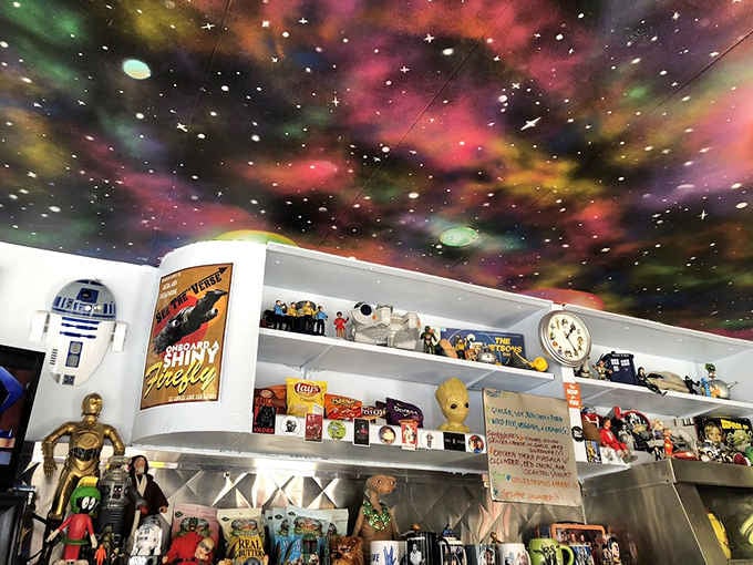 That cosmic ceiling paired with shelves of collectibles creates the ultimate nostalgic dining atmosphere imaginable.
