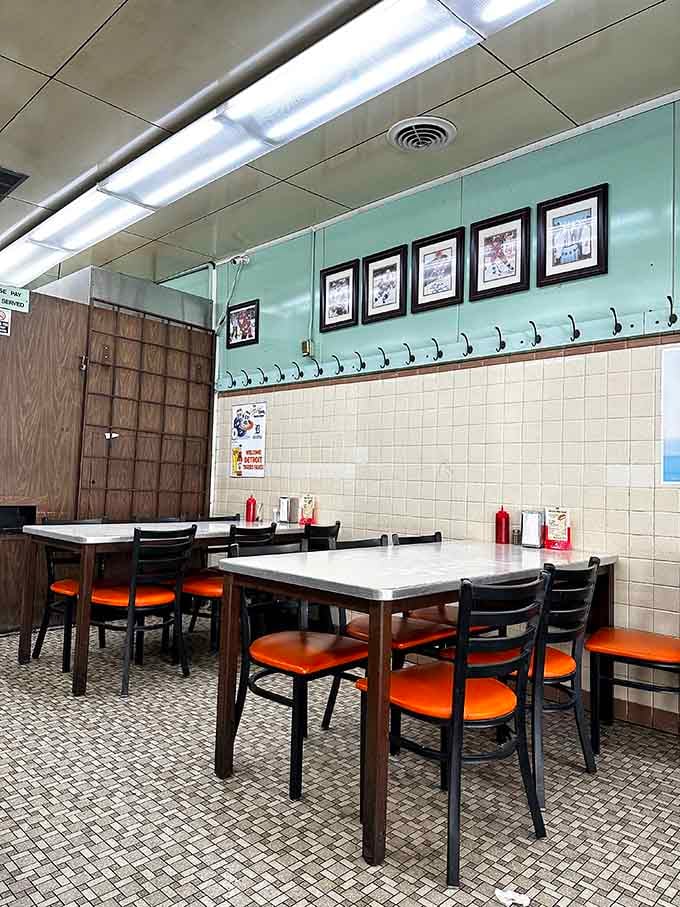 Retro mint walls, white tables, and orange seats create a dining room that's remained wonderfully unchanged through the decades.