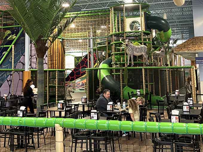 Dining tables surrounded by jungle theming make chicken tenders taste like an exotic safari adventure somehow.