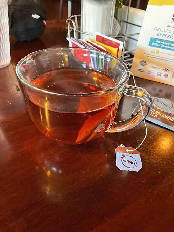 Hot tea served properly in a clear glass mug, steam rising like morning mist over the Willamette.