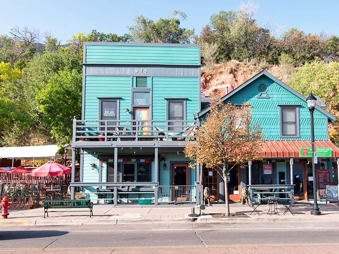 Colorful turquoise storefronts line the streets, proving that bold architectural choices create unforgettable small-town character.