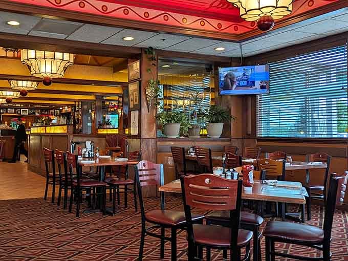 The dining room glows with warmth, wood paneling, and the promise of a meal you'll remember fondly.