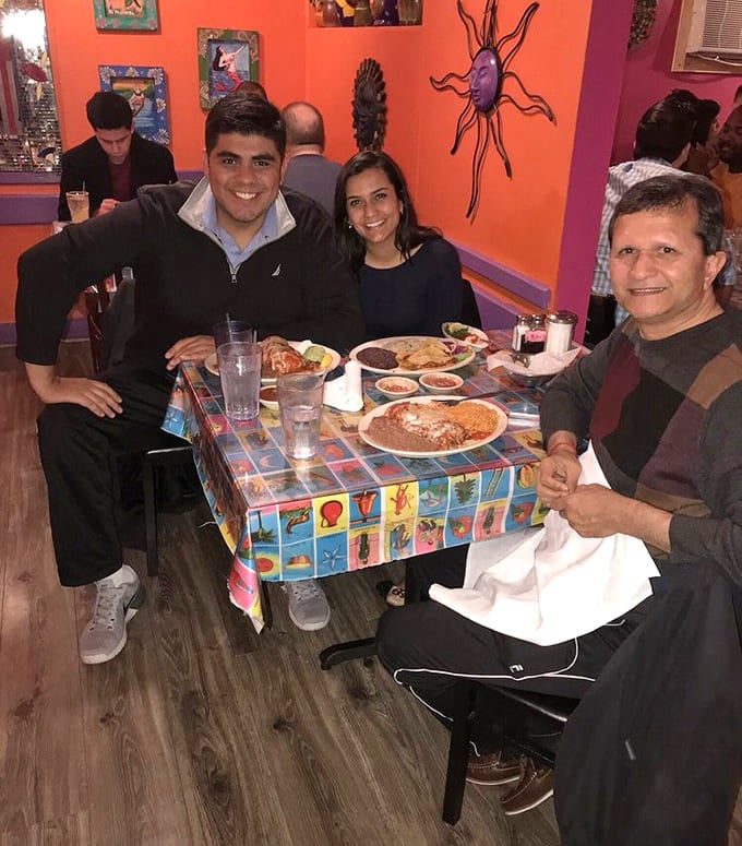 Happy diners gathered around colorful tablecloths enjoying good food and company is what Tex-Mex dining is all about, folks.
