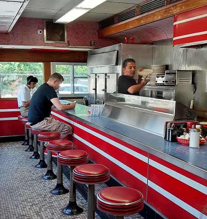 Those red vinyl counter stools have supported more late-night conversations than a therapist's couch ever could.