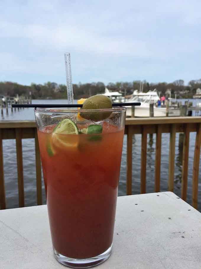 A Bloody Mary garnished with enough fixings to qualify as a meal, sitting pretty against the South River like liquid brunch perfection.