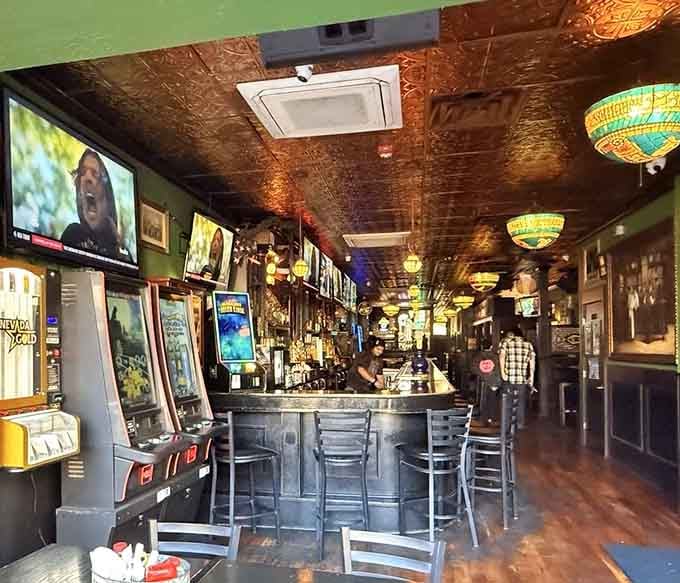 The bar stretches invitingly beneath those gorgeous tin ceilings, promising good times and even better conversations ahead.