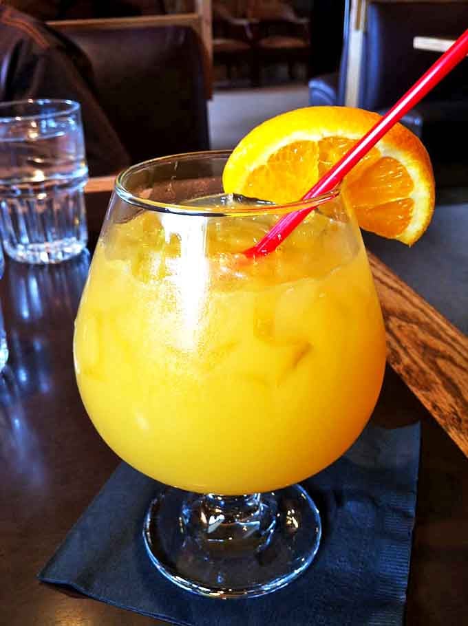 A mimosa the color of Cascade sunshine, garnished with an orange slice that's practically winking at you. Breakfast's favorite cocktail, mountain-style.