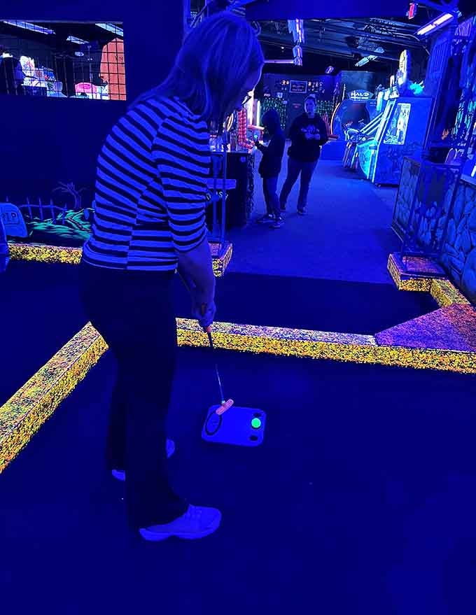 Stripes glow like a zebra at a disco, proving that fashion choices become infinitely more interesting under blacklight.