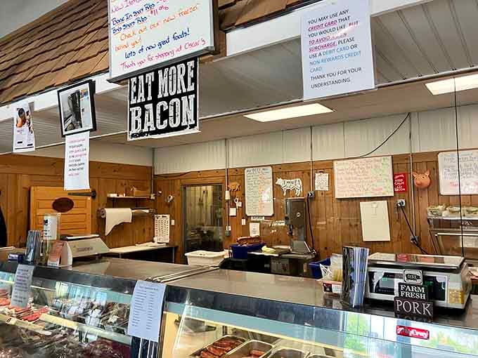 The counter where magic happens and the "Eat More Bacon" sign speaks truth to power with unapologetic honesty.