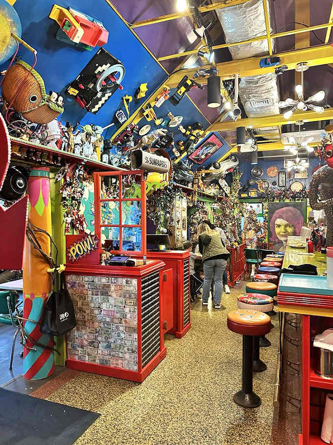 The bar area proves that even the drink station deserves its own collection of vintage treasures and toys.