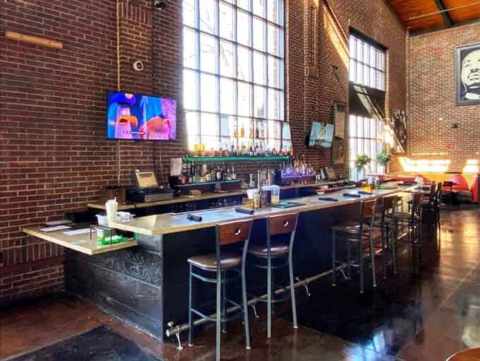 The bar area features soaring ceilings and exposed brick, making it perfect for unwinding with something cold.