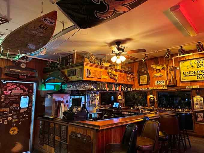 The bar area decorated with vintage signs and surfboards, where every inch of wall space earns its keep with character.