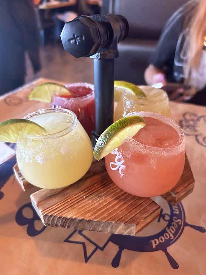 Four colorful margaritas lined up like edible rainbows make choosing just one flavor an impossible but delightful challenge.