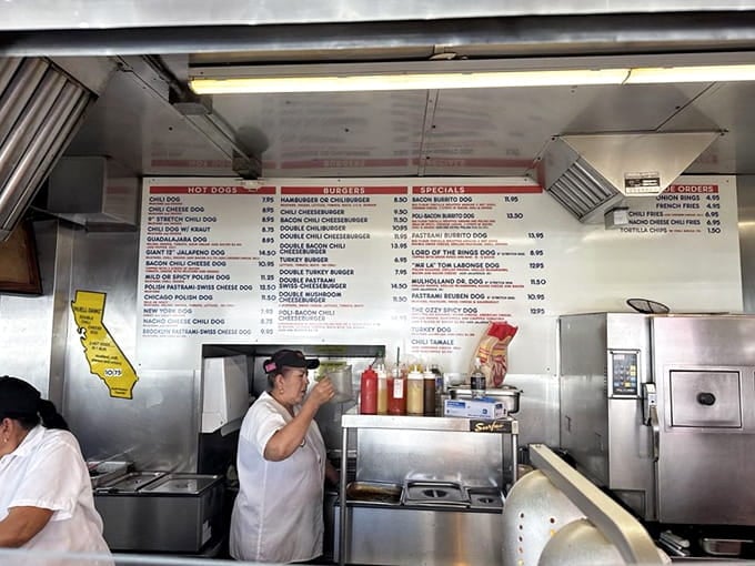 Behind that counter, efficiency meets decades of experience as orders fly faster than you can say extra chili.