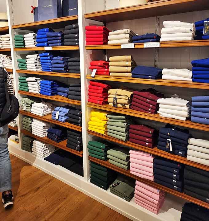 A rainbow of polos stacked with military precision&mdash;because nothing says "I'm casually put together" like a perfectly folded shirt collection.