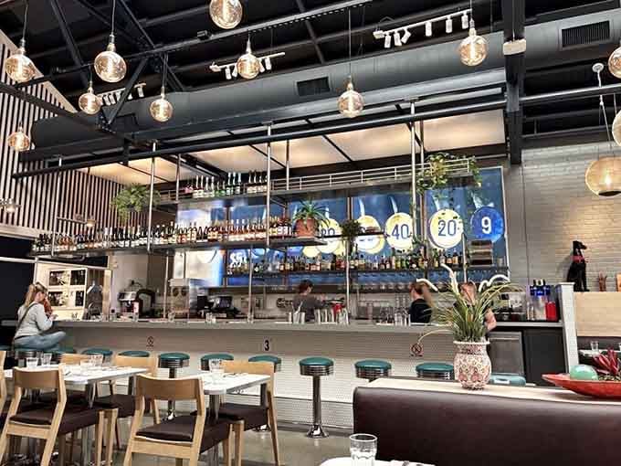 Counter seating with vintage red stools where you can watch kitchen wizardry happen right before you.