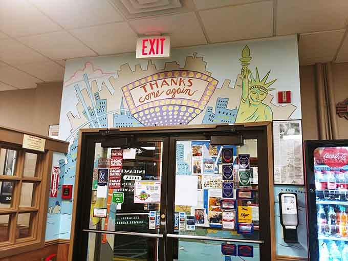 That "Thanks Come Again" mural over the exit ensures New York follows you out the door.