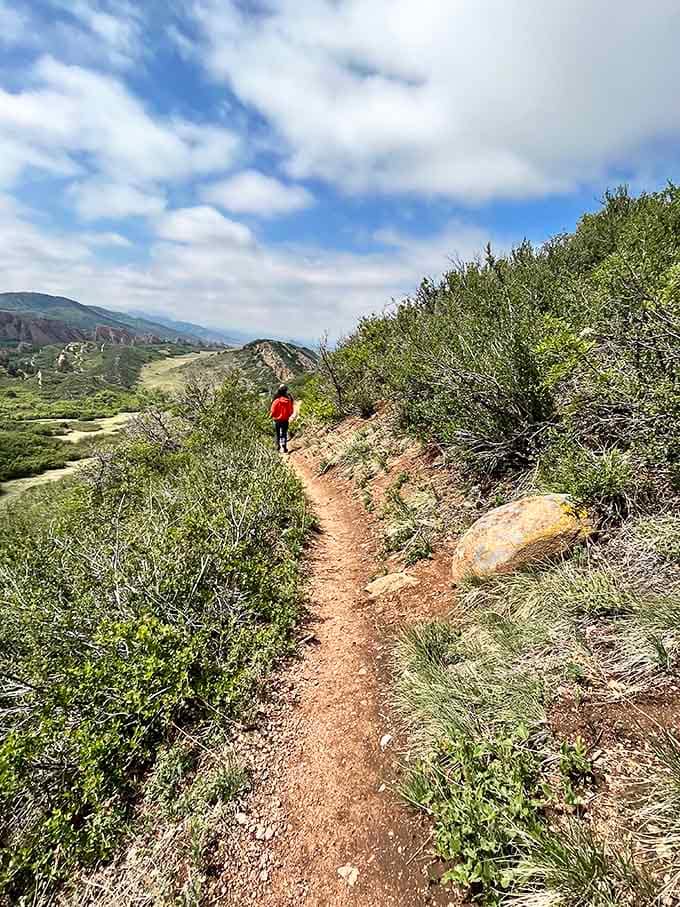 Winding trails through golden grasslands invite exploration without the intimidation factor of serious mountain climbing required.