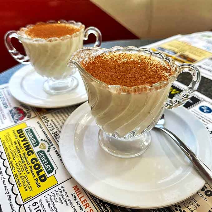 Cream and cinnamon in delicate glassware&mdash;proof that diners understand presentation matters even when the food is comforting rather than fancy.