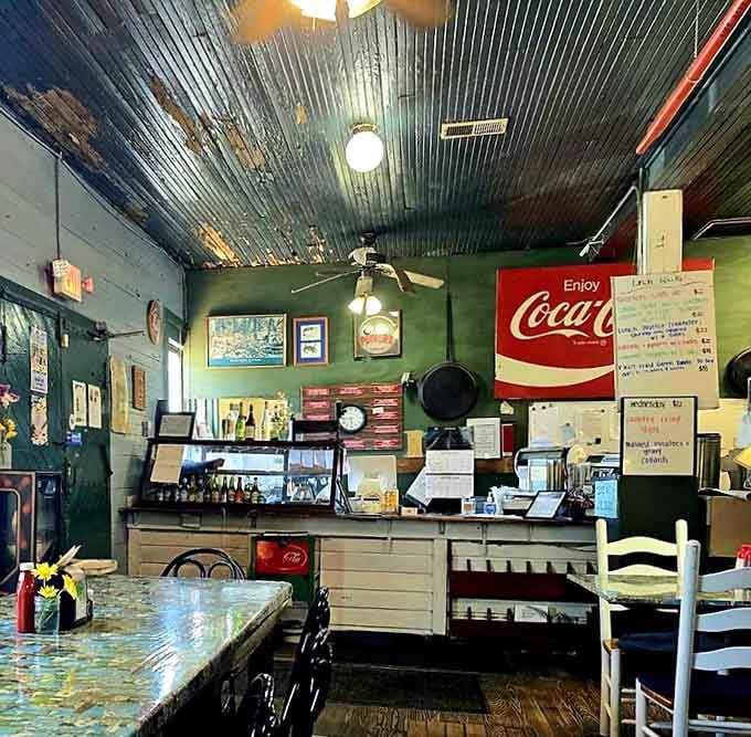 That vintage Coca-Cola sign and tin ceiling tell you everything about priorities here: tradition over trends, always.