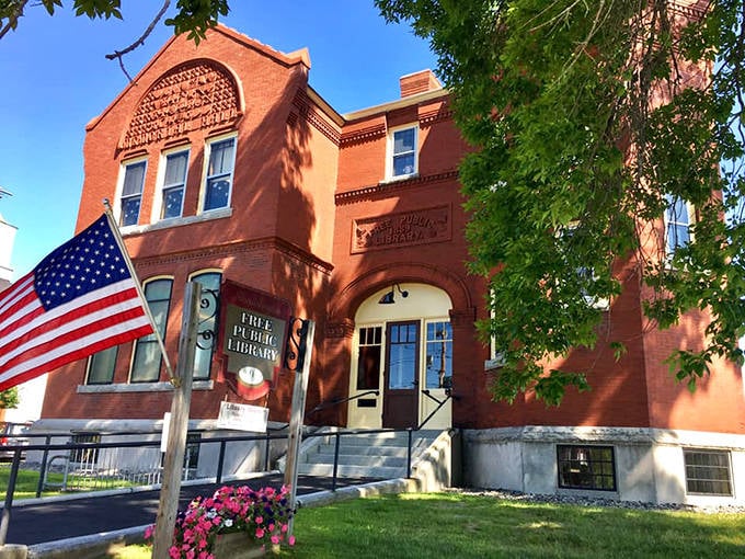 The Free Public Library's welcoming brick fa&ccedil;ade and American flag promise literary adventures for all, a cornerstone of community learning since the 19th century.