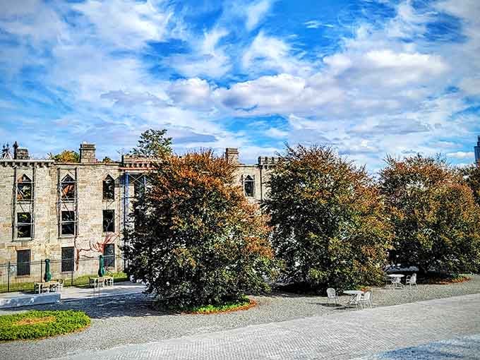 Autumn trees frame the ruins like a painting, proving that even dark history can become unexpectedly photogenic.