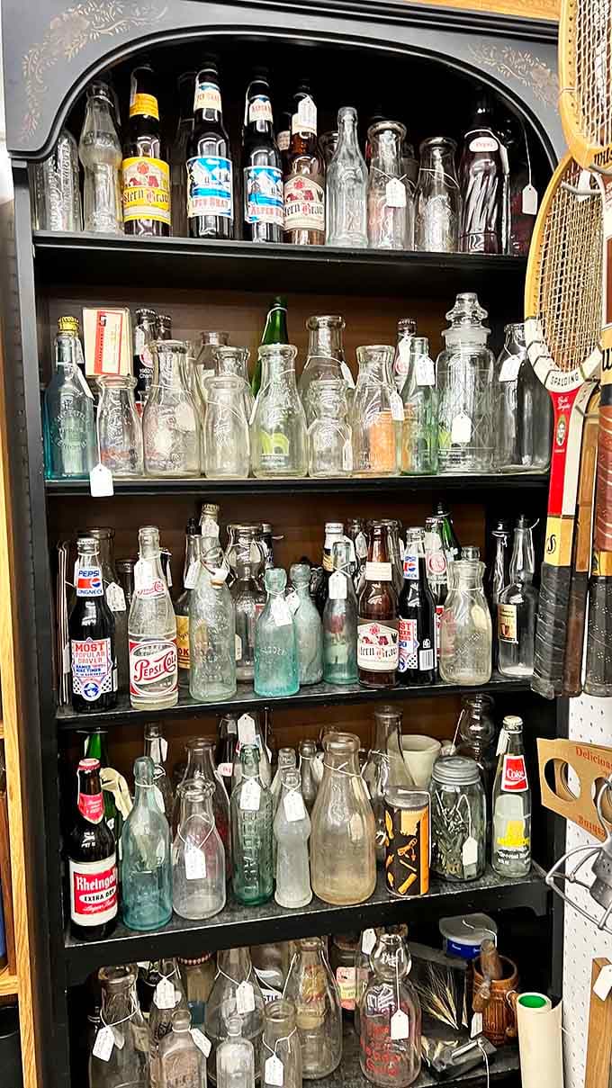Vintage soda bottles stand at attention like glass soldiers preserving brands from America's fizzy past.