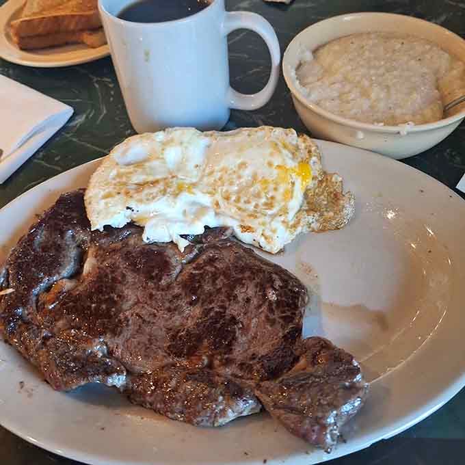 A perfectly cooked steak with eggs and grits, because sometimes breakfast needs to be hearty enough to fuel your entire day ahead.