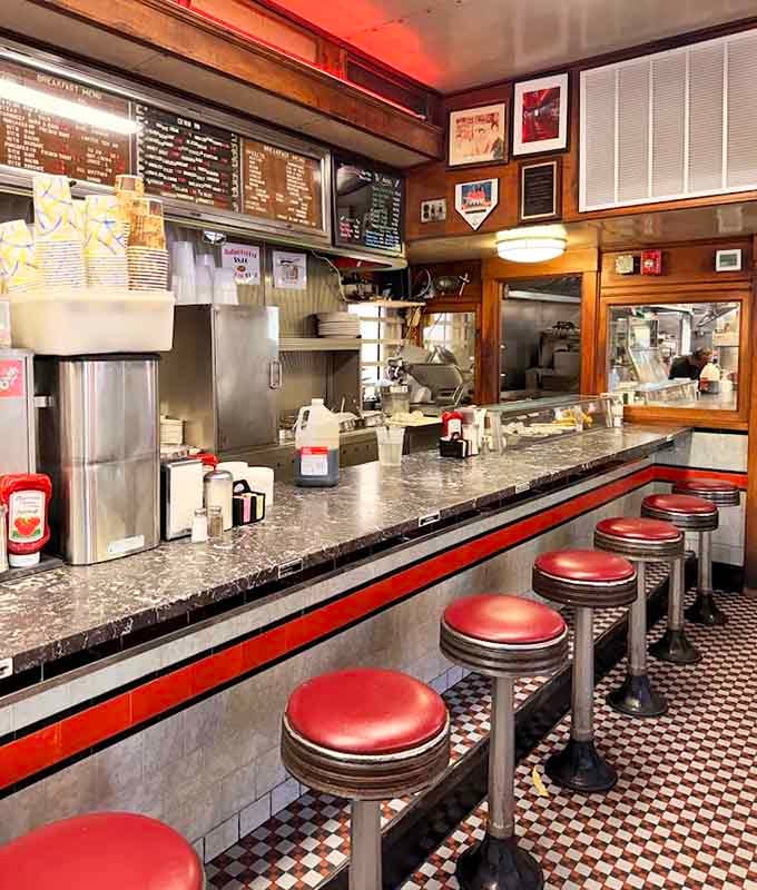 The counter seats offer front-row tickets to the breakfast ballet, where eggs and hash browns dance together.