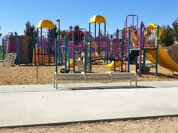 Sunset Ridge Park's vibrant playground equipment stands ready for family adventures, proving Victorville understands the universal language of "wheeeee!"