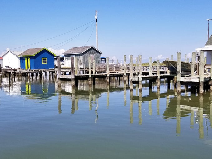 Colorful shanties on stilts create a waterfront scene that looks like a child's drawing come to life.